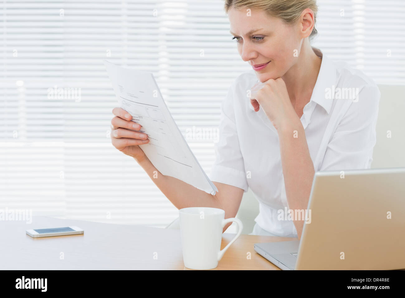 Caucasian businesswoman reading paper hi-res stock photography and ...