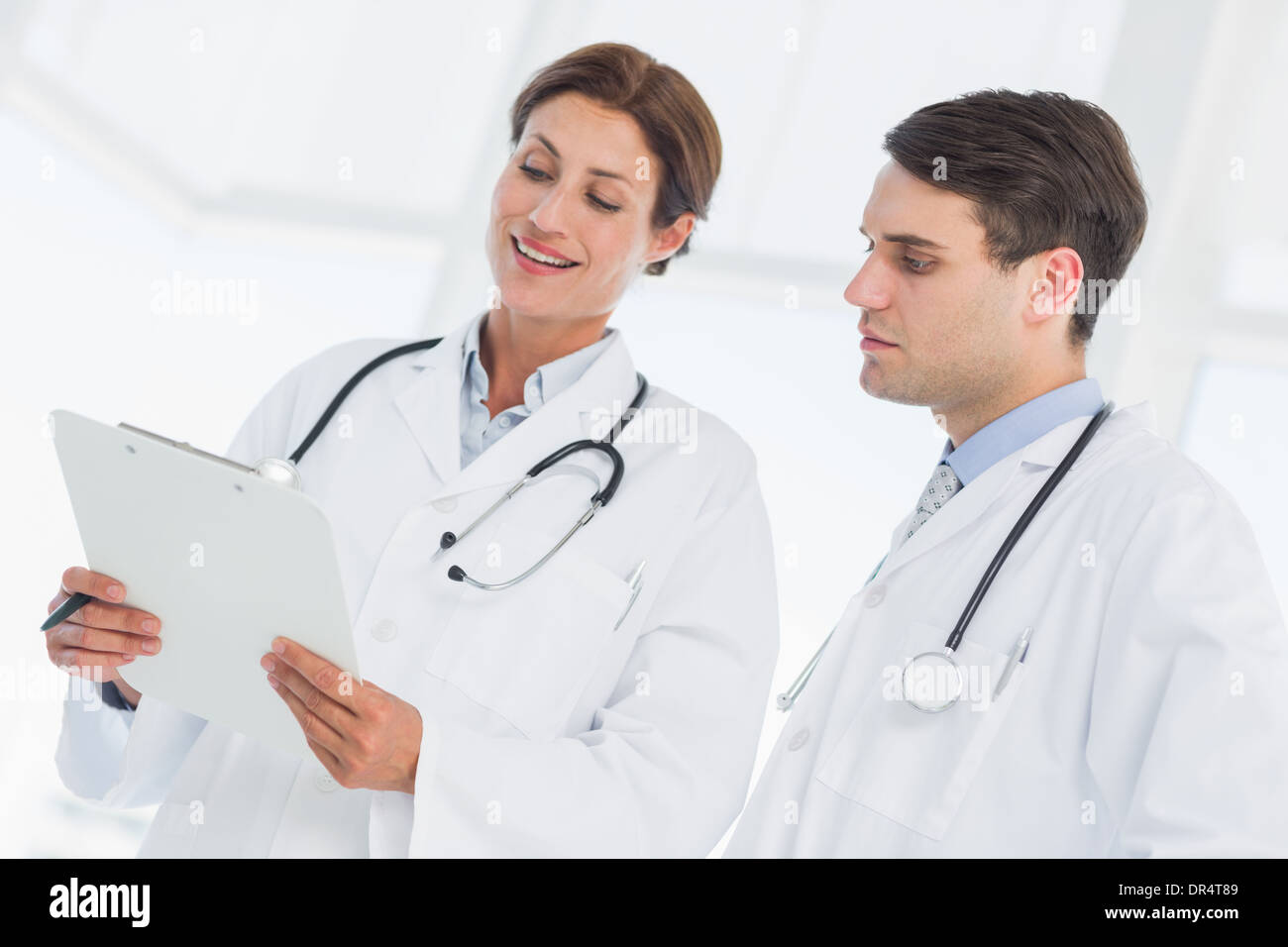 Doctors looking at report in hospital Stock Photo - Alamy