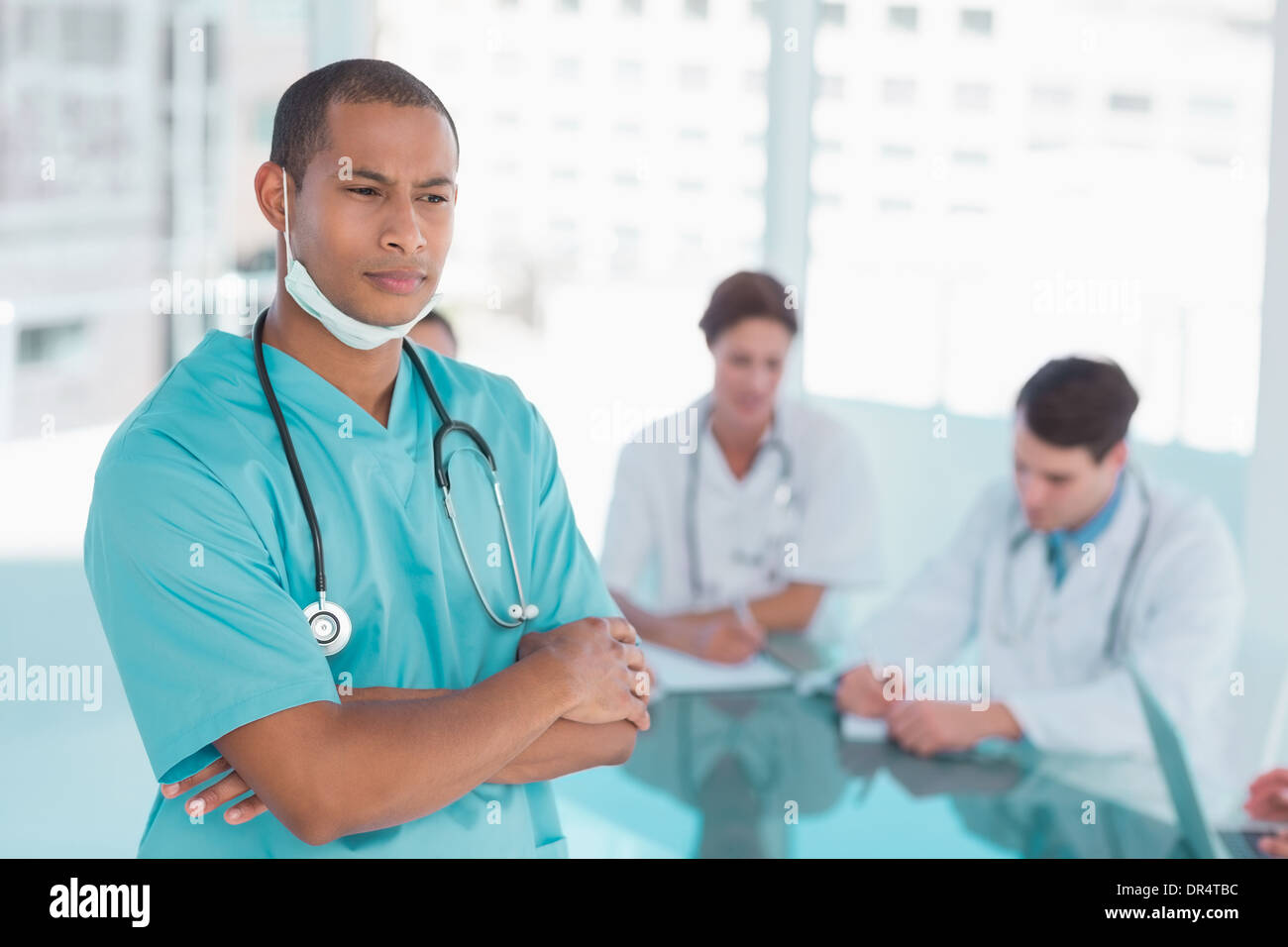 Surgeon standing with group around table in hospital Stock Photo - Alamy