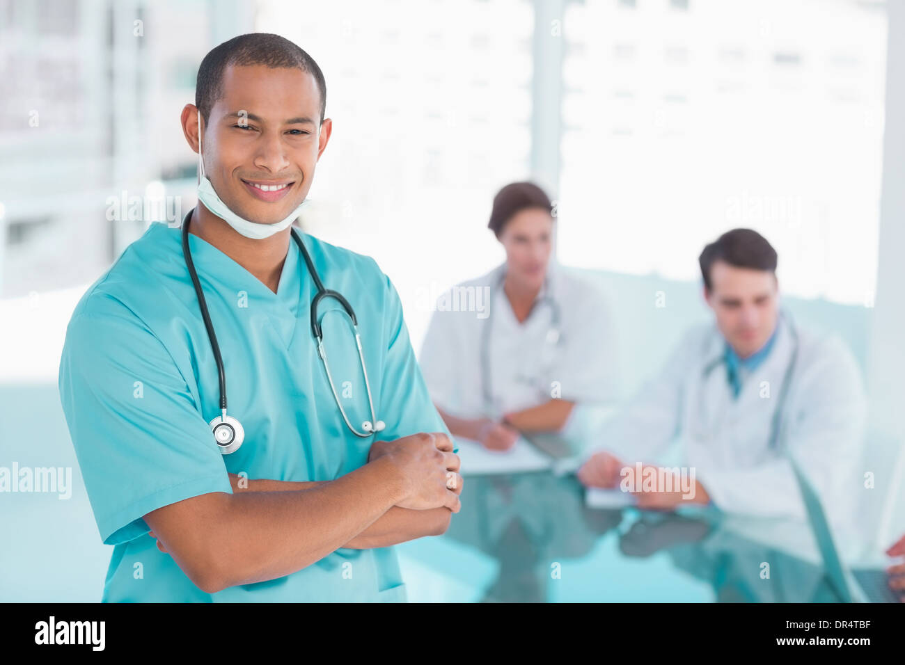 Surgeon standing with group around table in hospital Stock Photo - Alamy