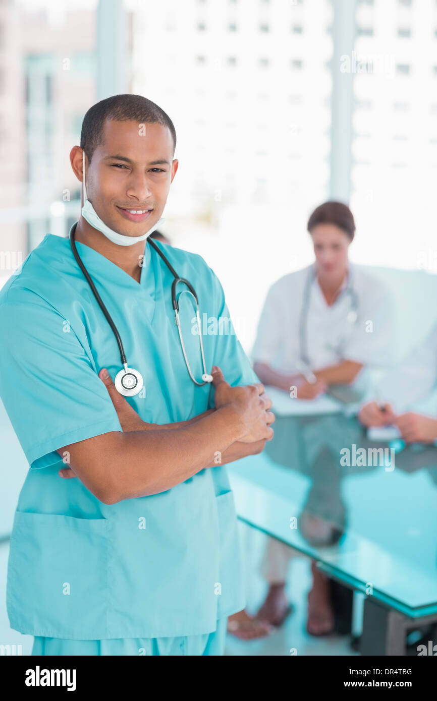 Surgeon standing with group around table in hospital Stock Photo - Alamy