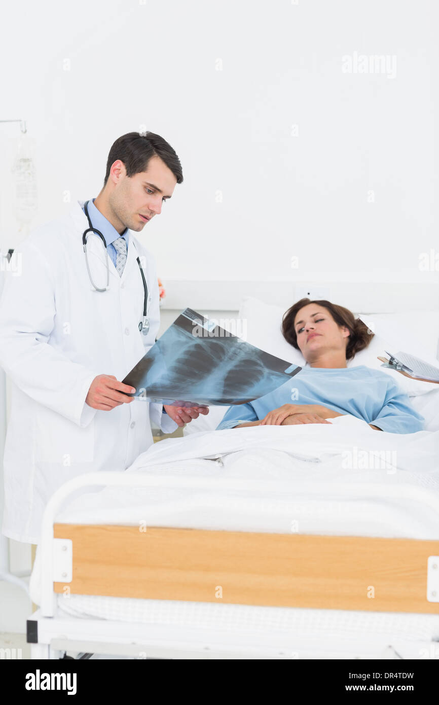 Doctor showing x-ray to female patient Stock Photo - Alamy