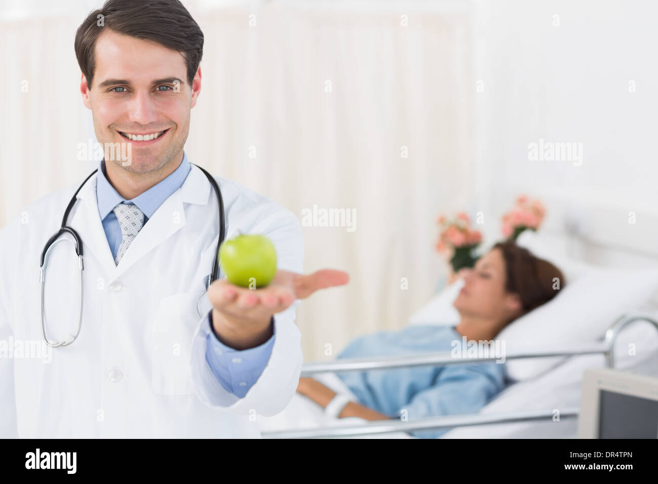 Medical doctor offering apple patient hi-res stock photography and ...