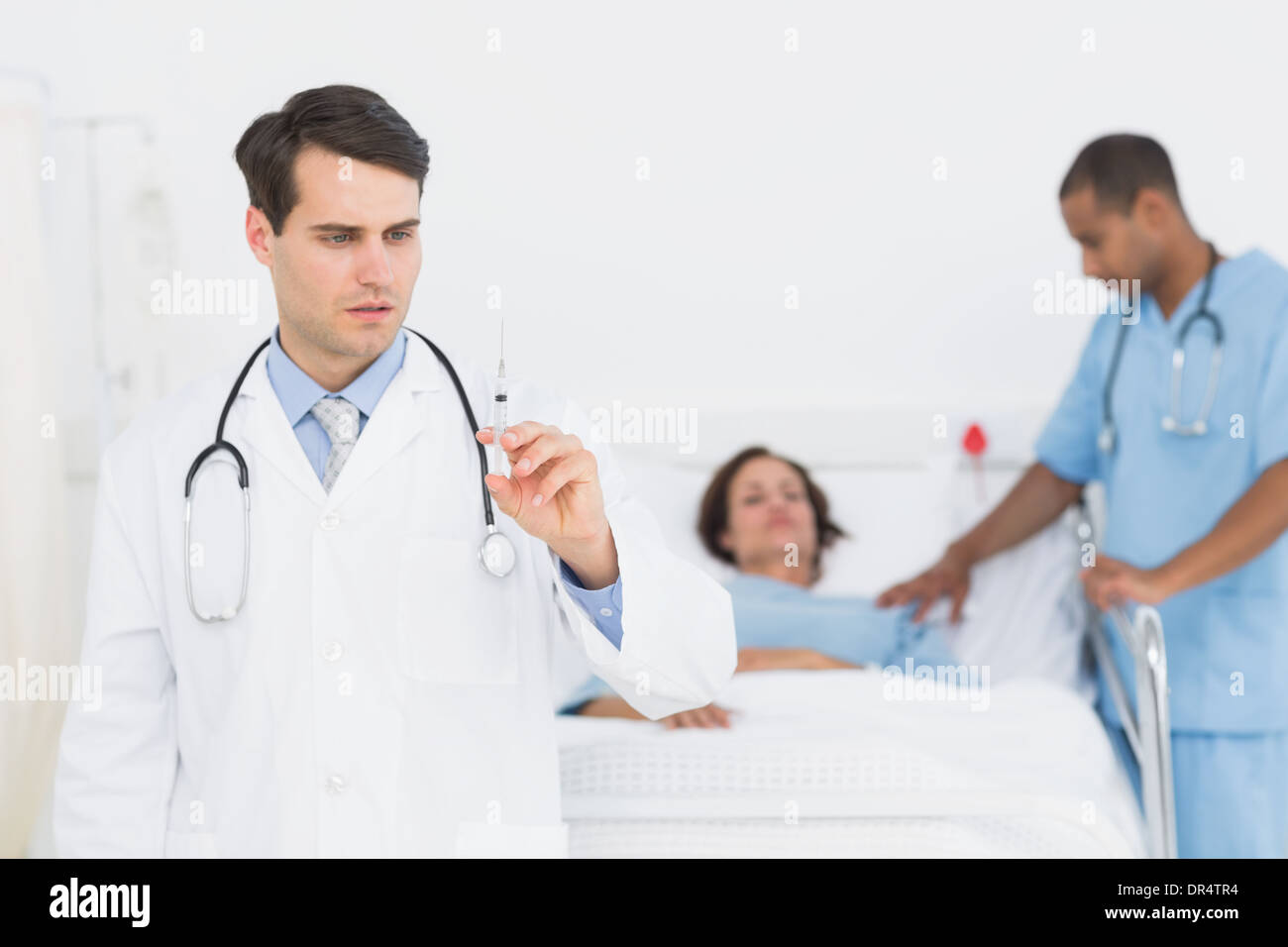 Doctor injecting patient in clinic hi-res stock photography and images ...