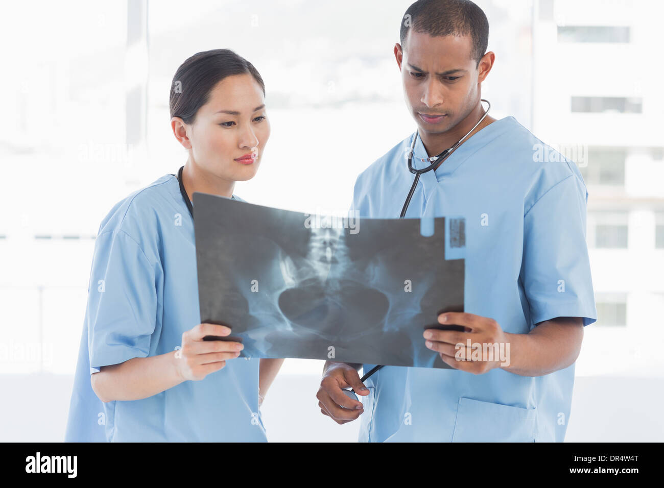 Two surgeons examining x-ray Stock Photo - Alamy