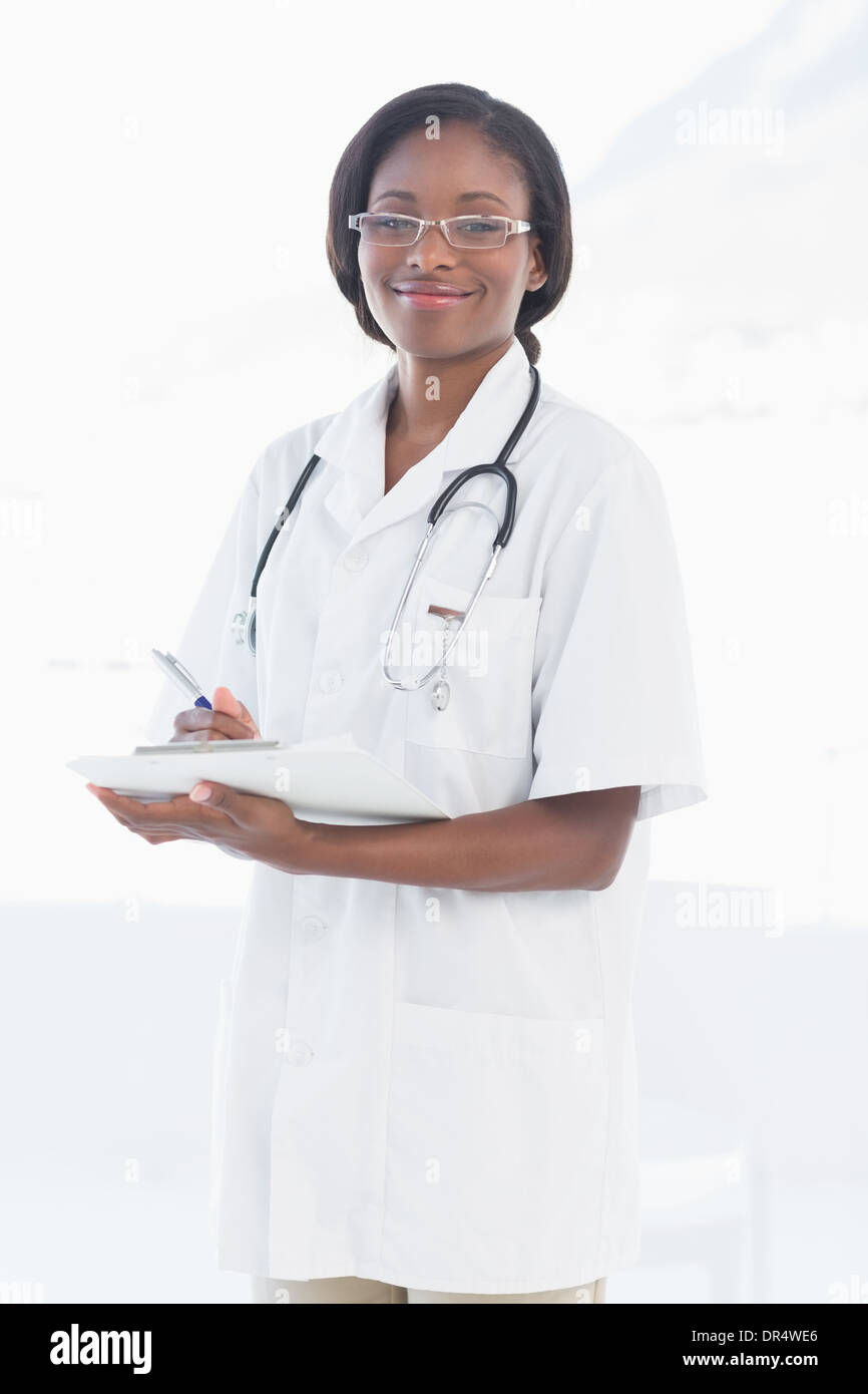 Portrait of a smiling female doctor with report Stock Photo - Alamy