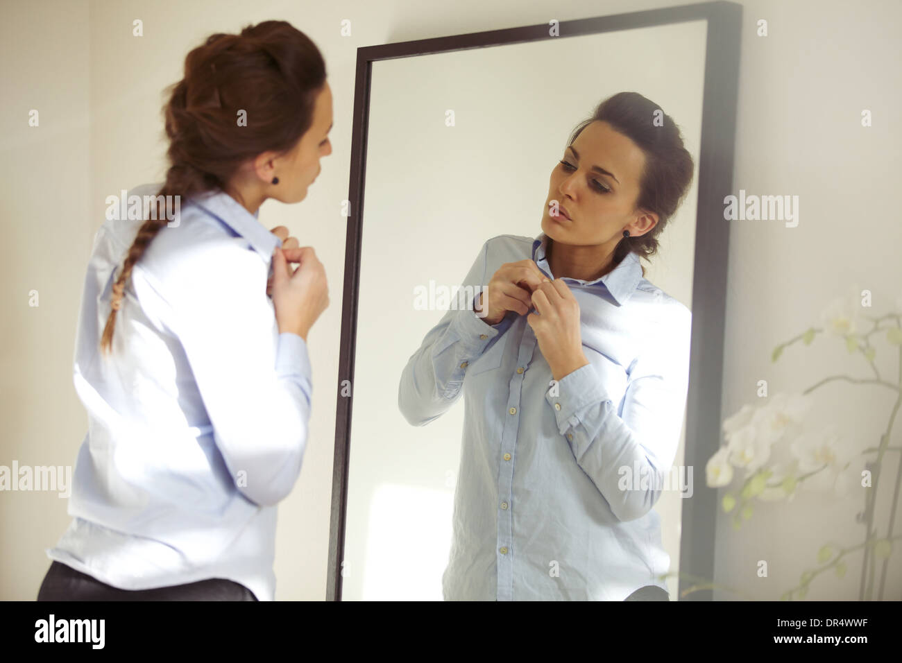 Young woman getting dressed work hi-res stock photography and images ...