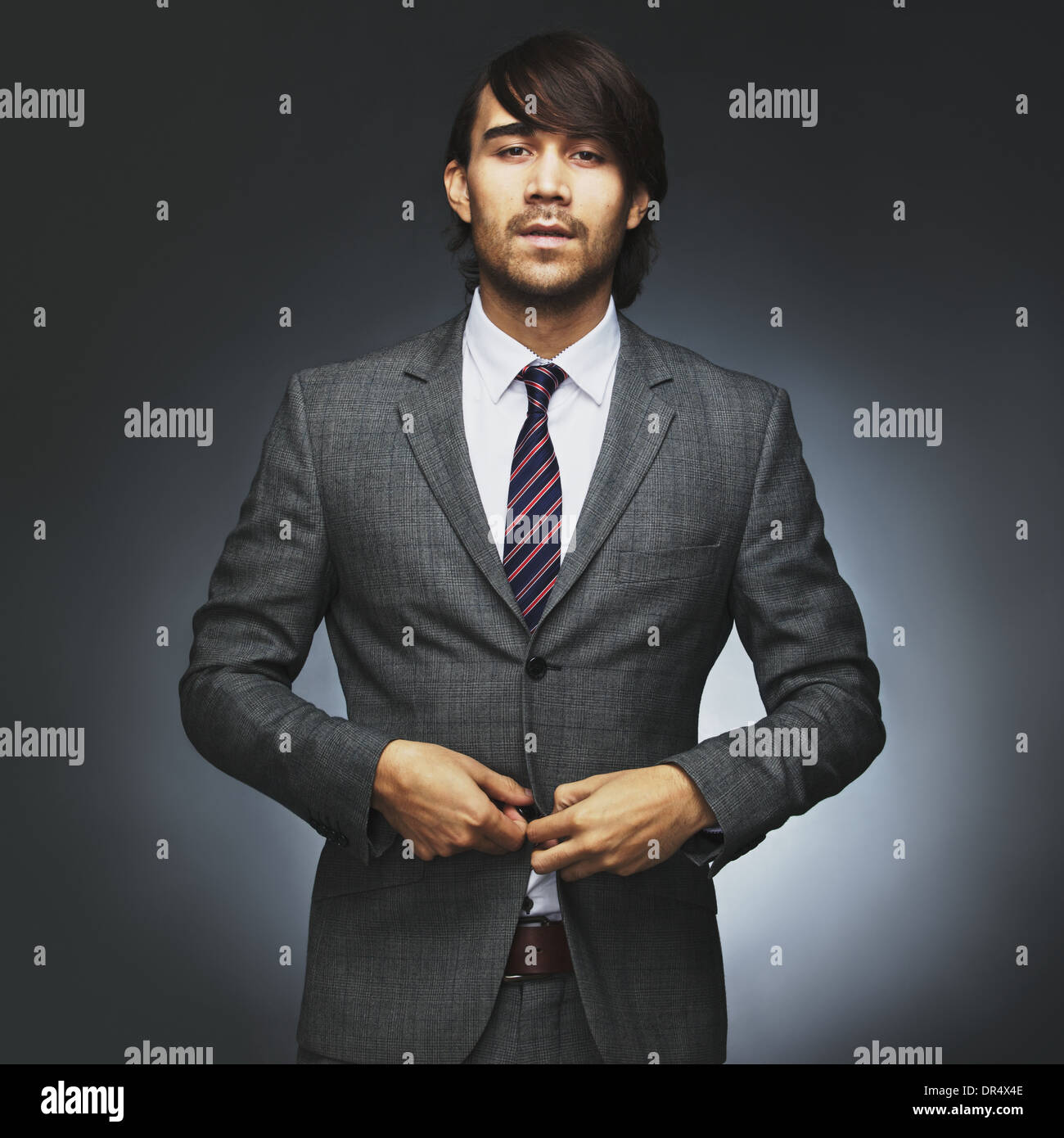 Portrait of attractive young male model wearing stylish suit ...
