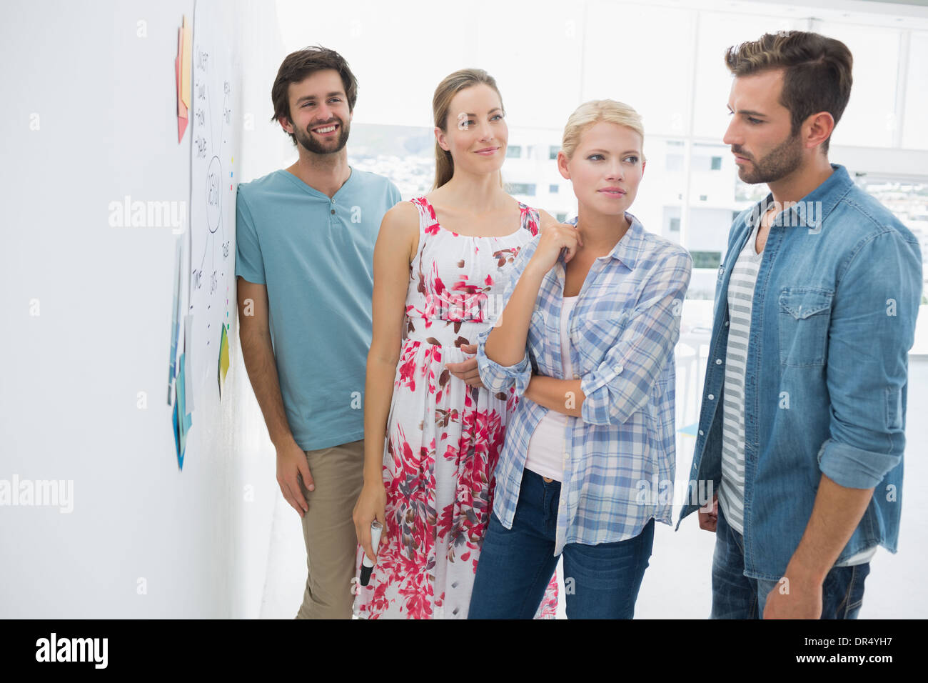 Artists in discussion in front of whiteboard Stock Photo - Alamy