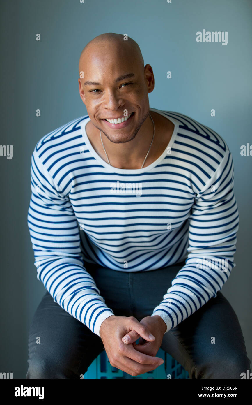 Mixed race man in striped shirt Stock Photo - Alamy