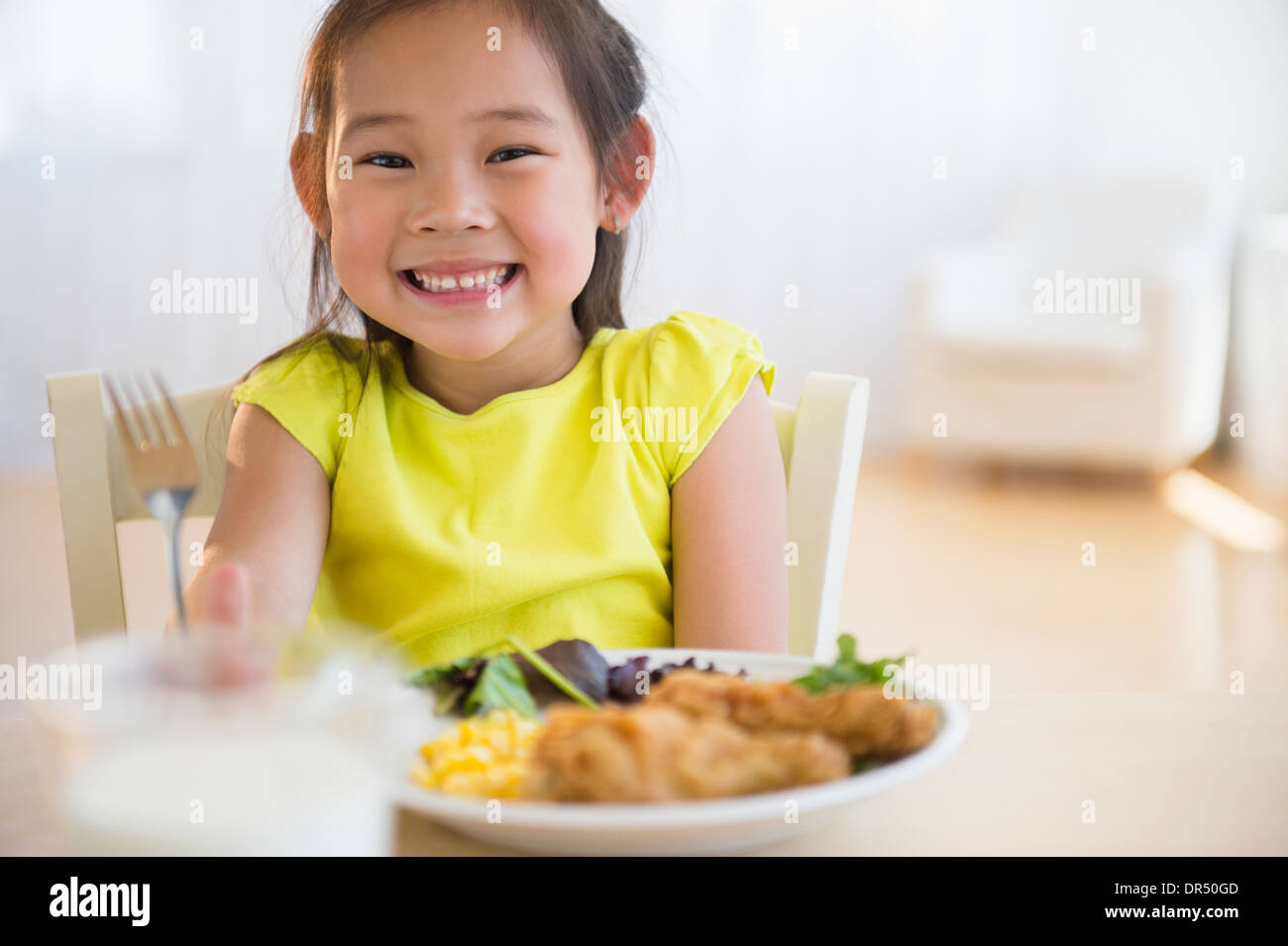 Korean girl eating dinner at table Stock Photo - Alamy