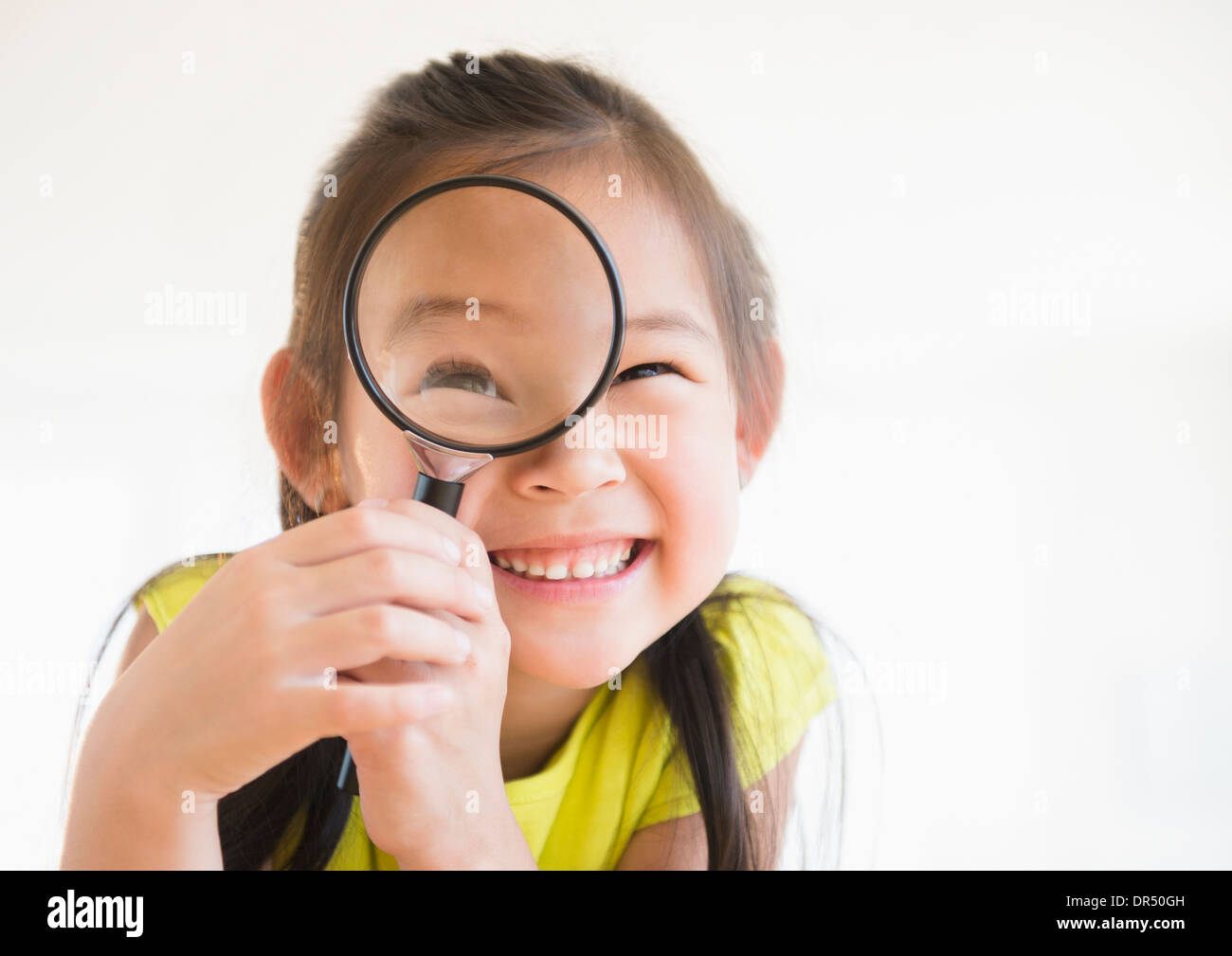 Korean girl using magnifying glass Stock Photo - Alamy