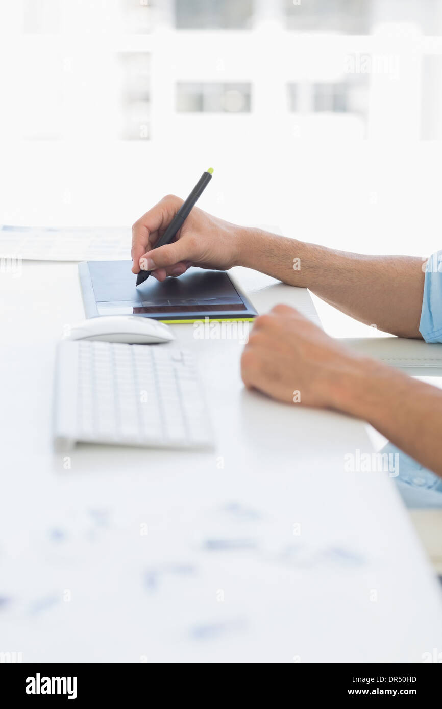 Casual male photo editor using graphics tablet Stock Photo - Alamy