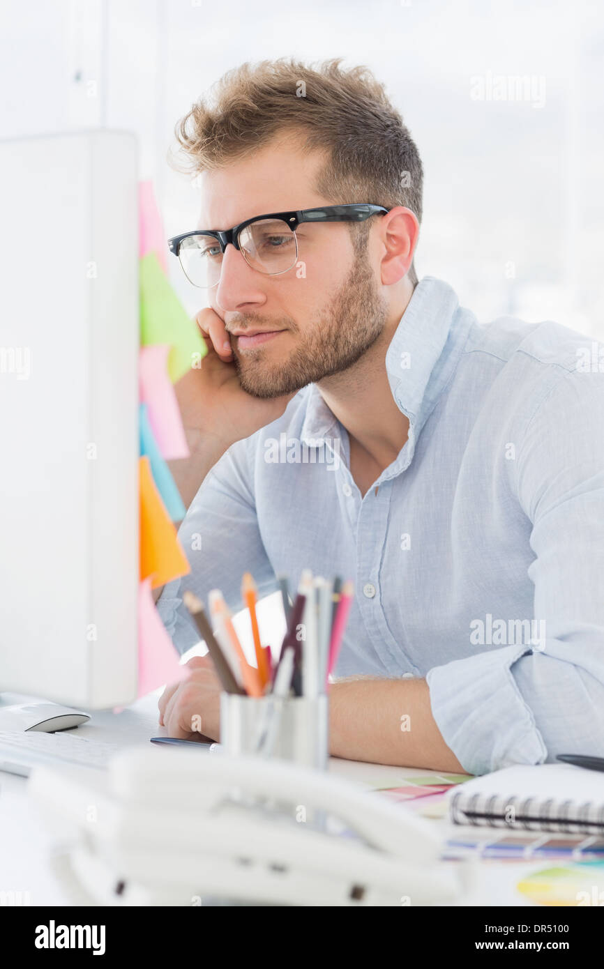 Serious young man using computer at hi-res stock photography and images ...