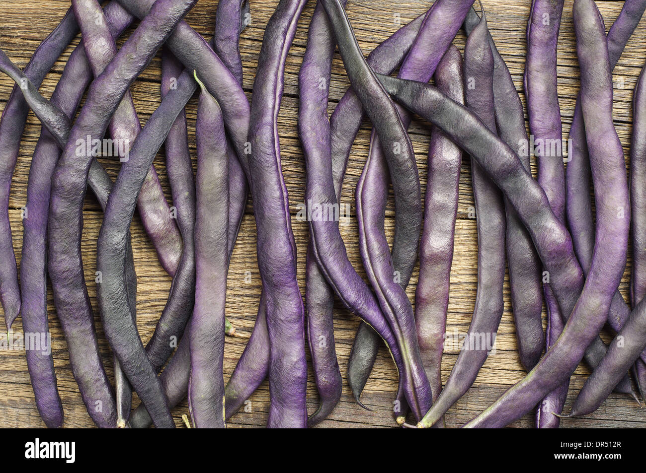 Background with purple string beans Stock Photo - Alamy