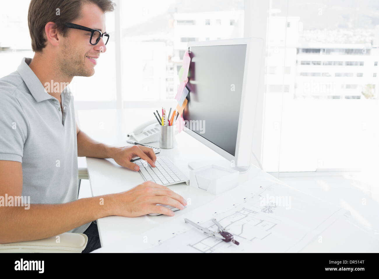 Side view of male photo editor working on computer Stock Photo - Alamy