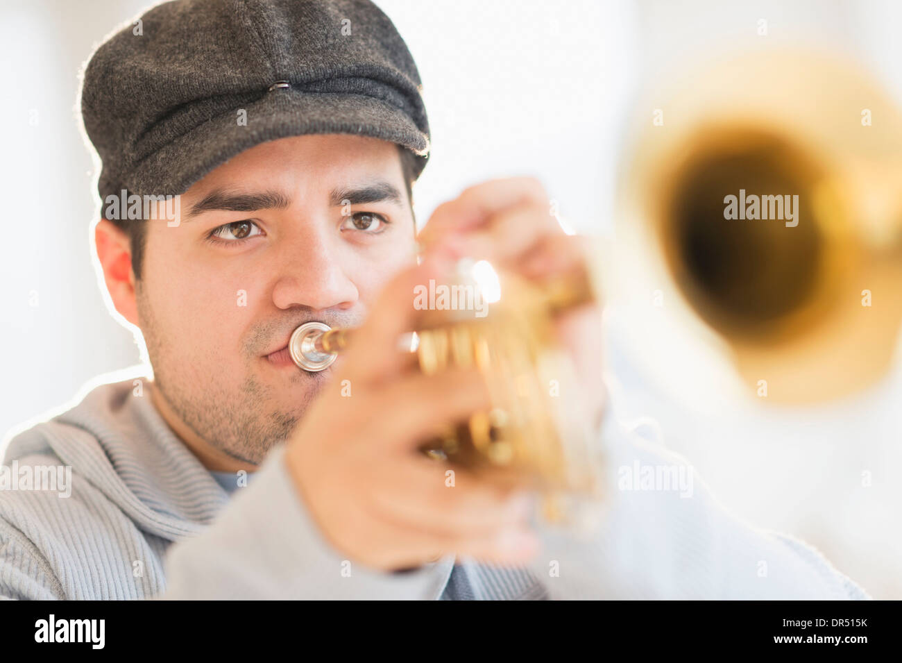 Mixed race man playing trumpet Stock Photo - Alamy