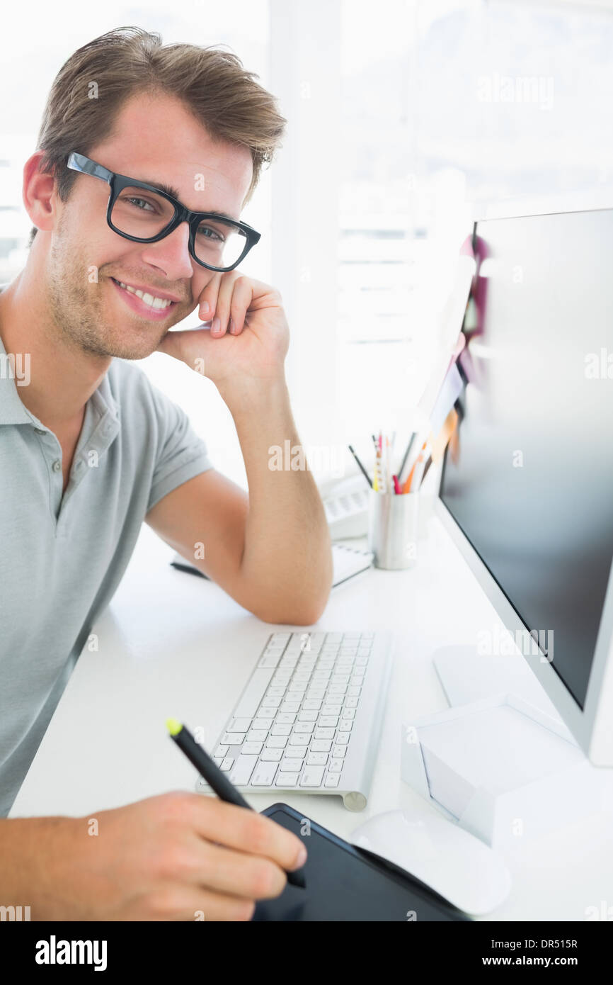 Side view of a casual male photo editor using graphics tablet Stock ...