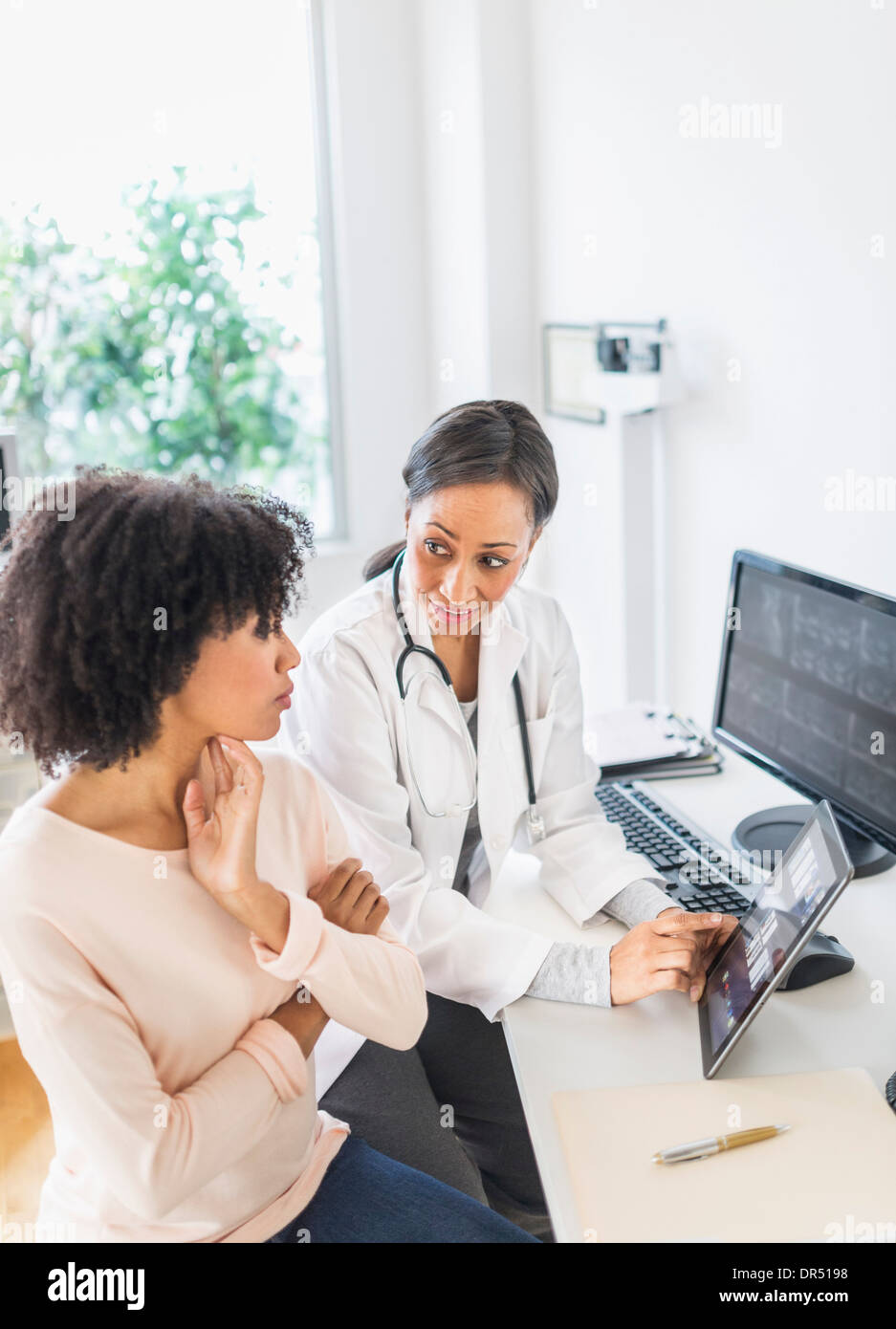 African American doctor and patient talking in office Stock Photo - Alamy