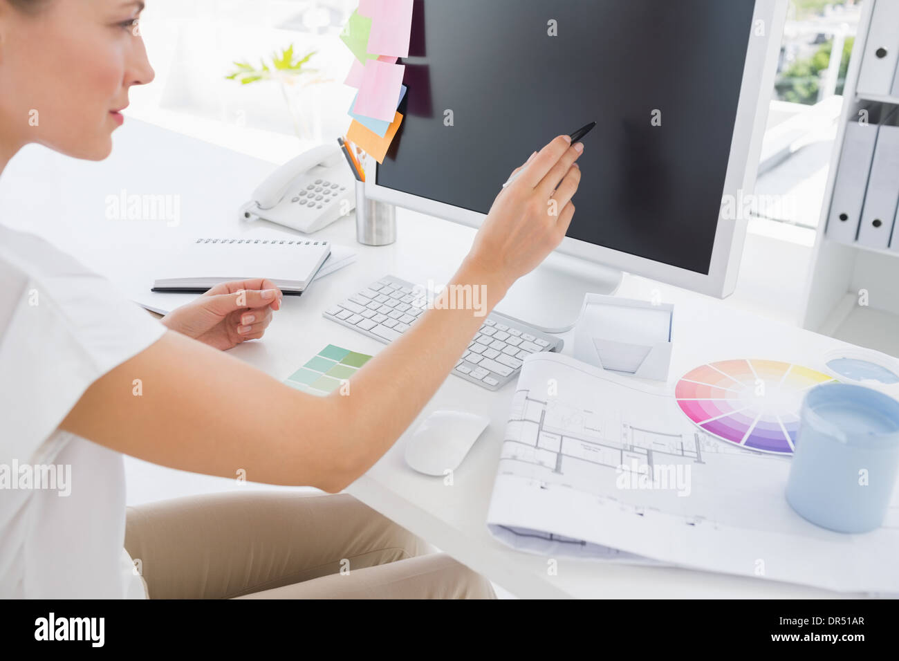 Side view of photo editor working on computer Stock Photo - Alamy