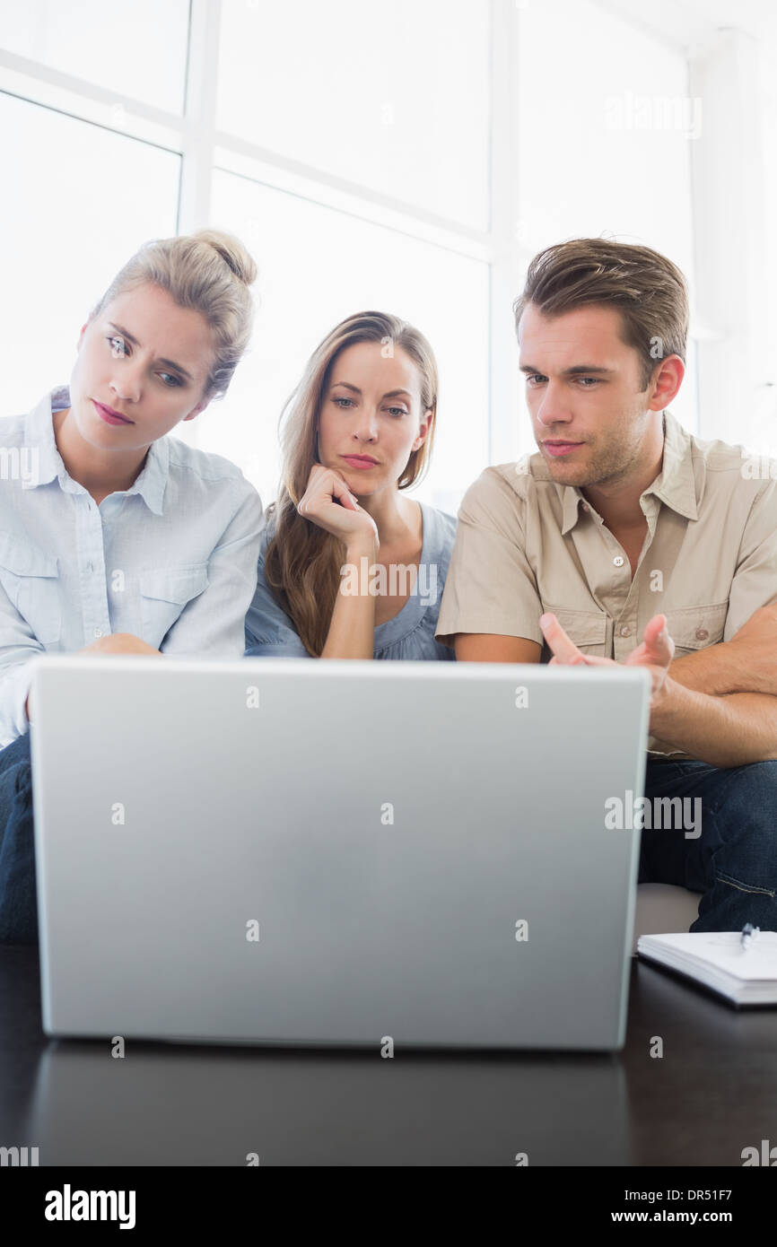 Three young people working on computer Stock Photo - Alamy