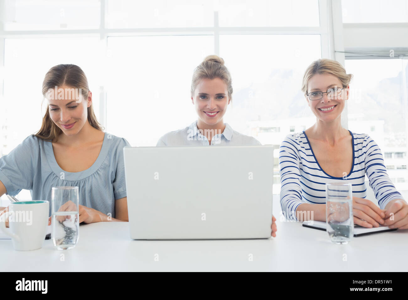 Three young people working in office Stock Photo - Alamy