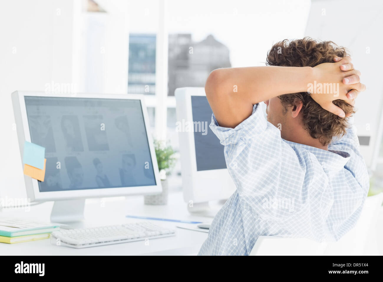 Young man sitting behind computer hi-res stock photography and images ...