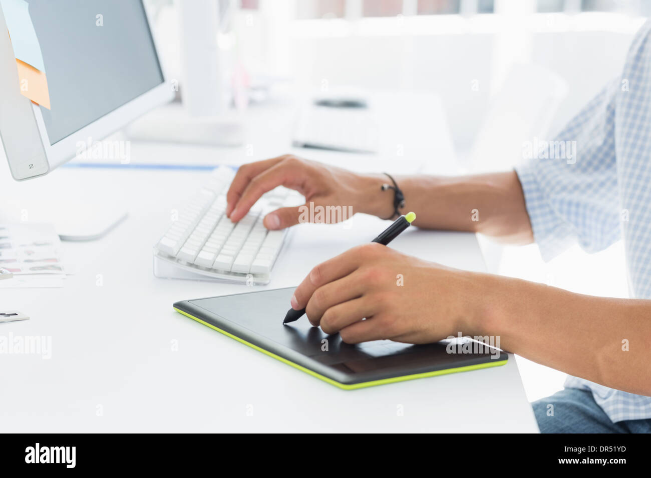 Artist drawing something on graphic tablet with pen Stock Photo - Alamy