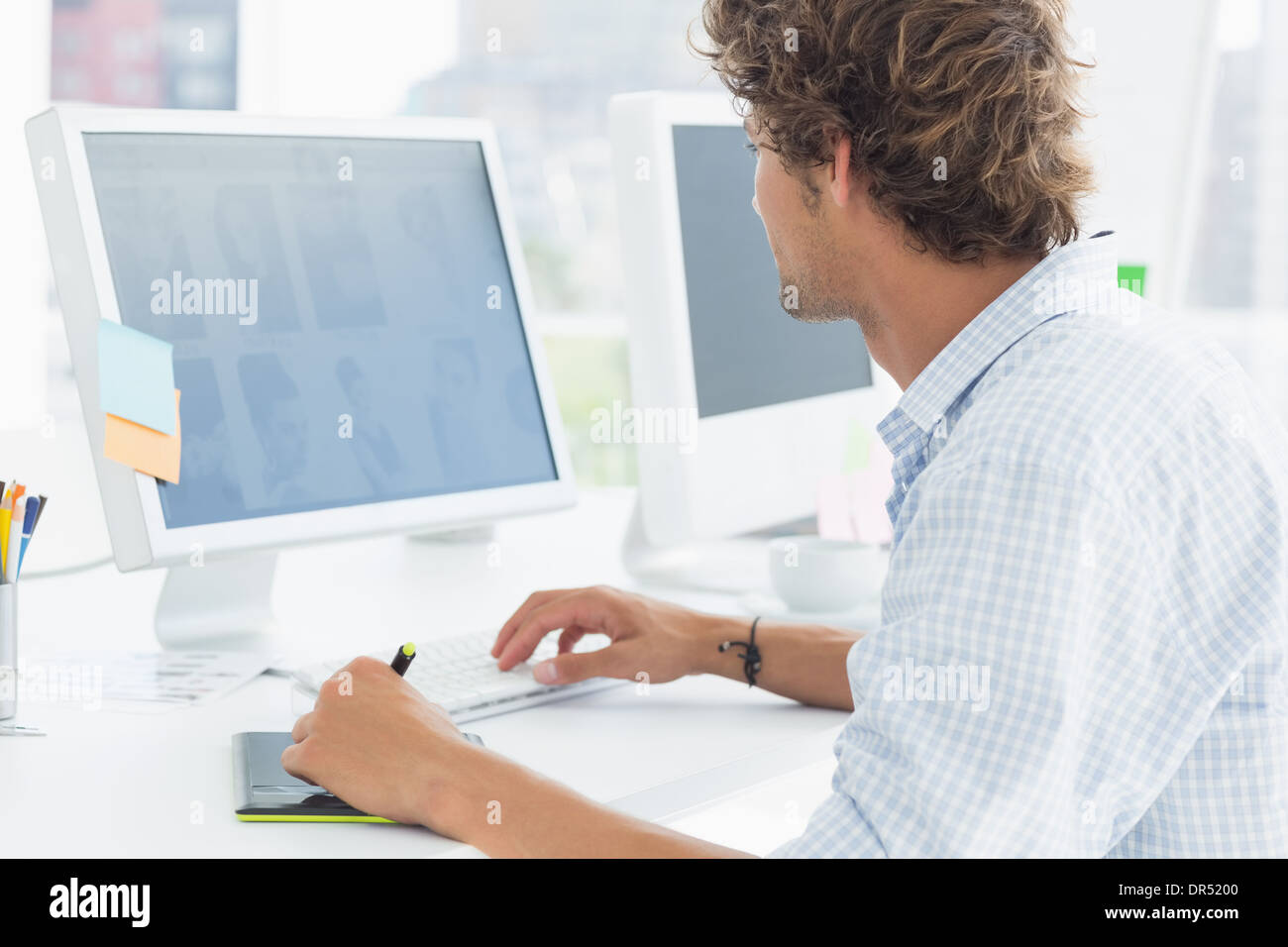 artist drawing something on graphic tablet with pen Stock Photo - Alamy