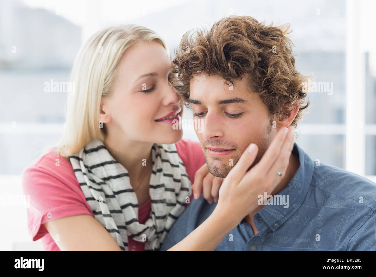 Young couple kiss on cheek hi-res stock photography and images - Alamy