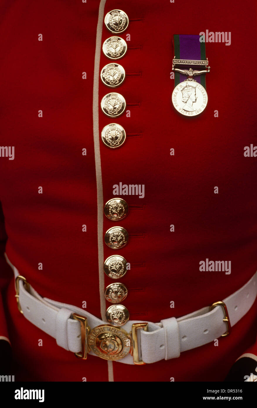 A detail of a Welsh Guard's red tunic uniform including a medal for ...