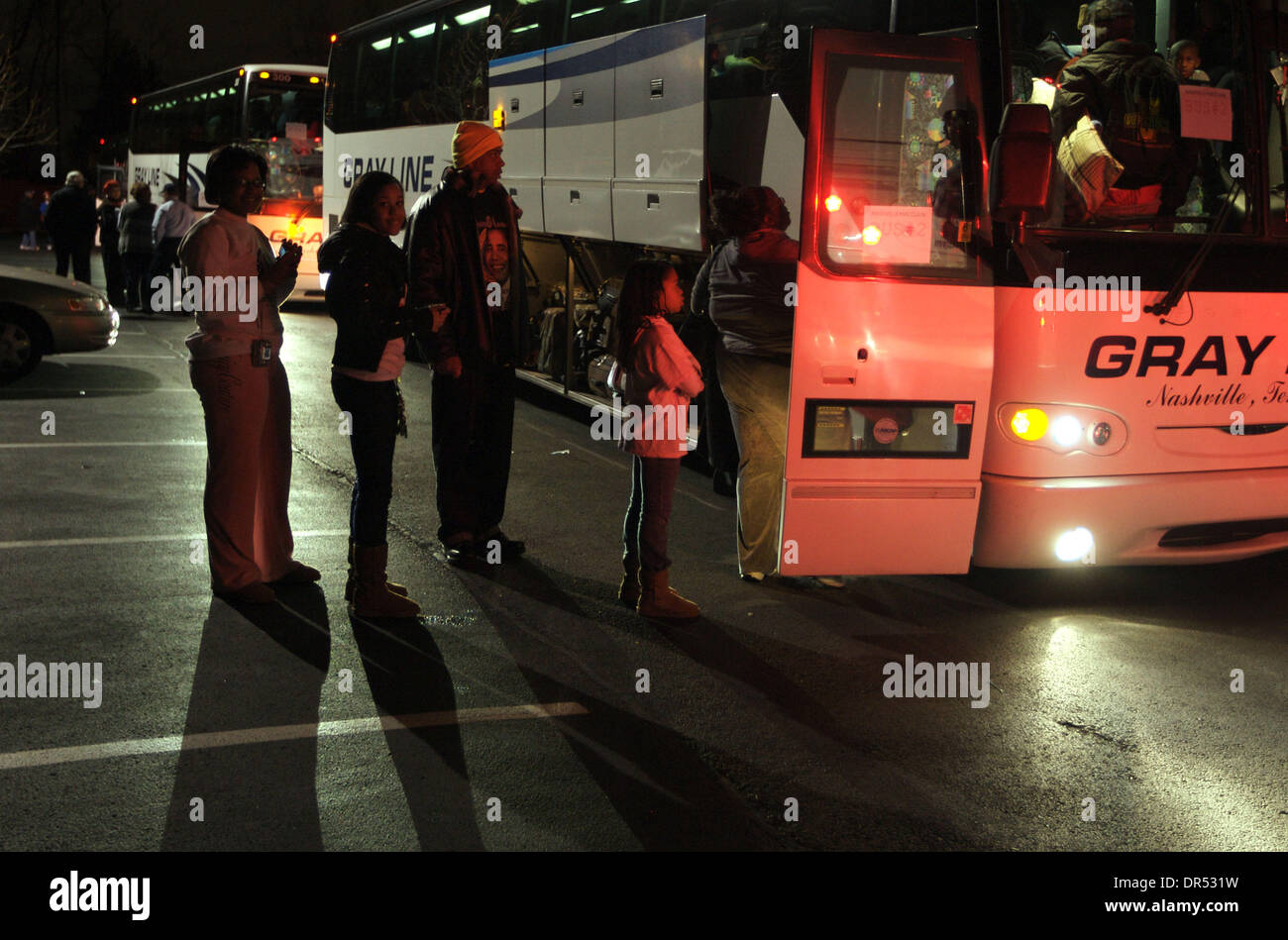 People load charter buses as they leave from Lake Providence Missionary ...
