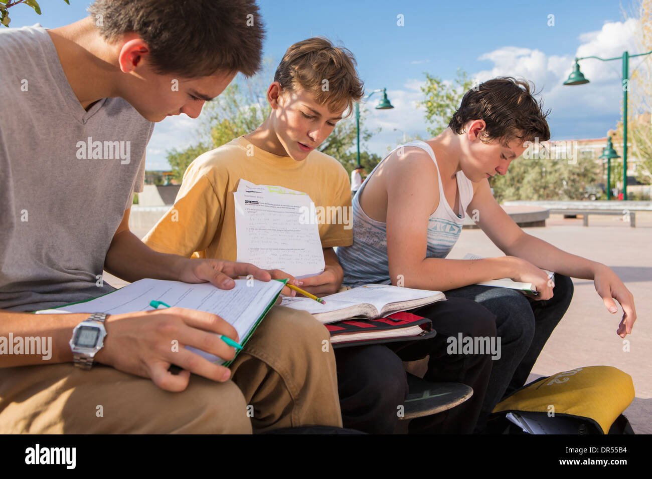 Teenage boys doing homework together outdoors Stock Photo - Alamy