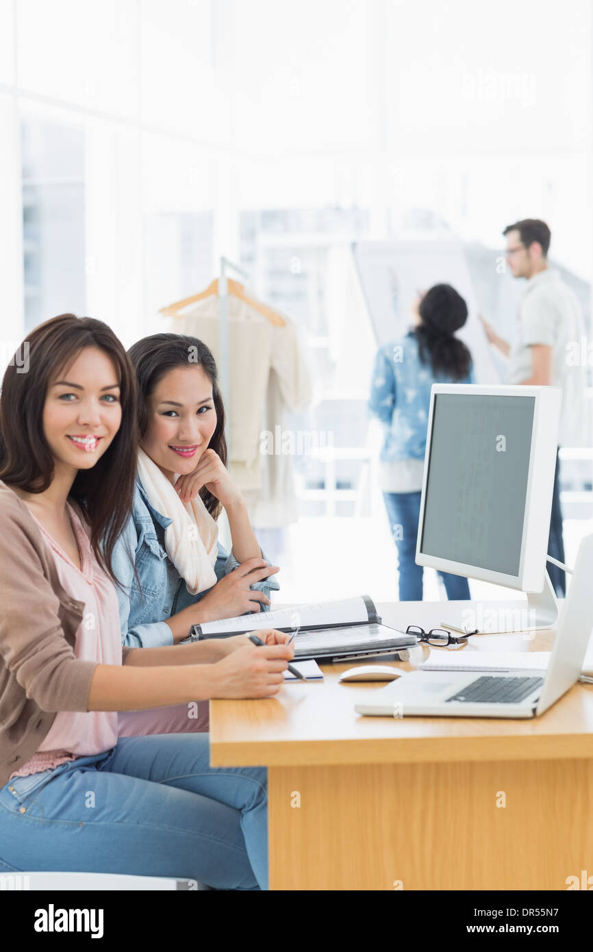 Female artists working at desk in creative office Stock Photo - Alamy