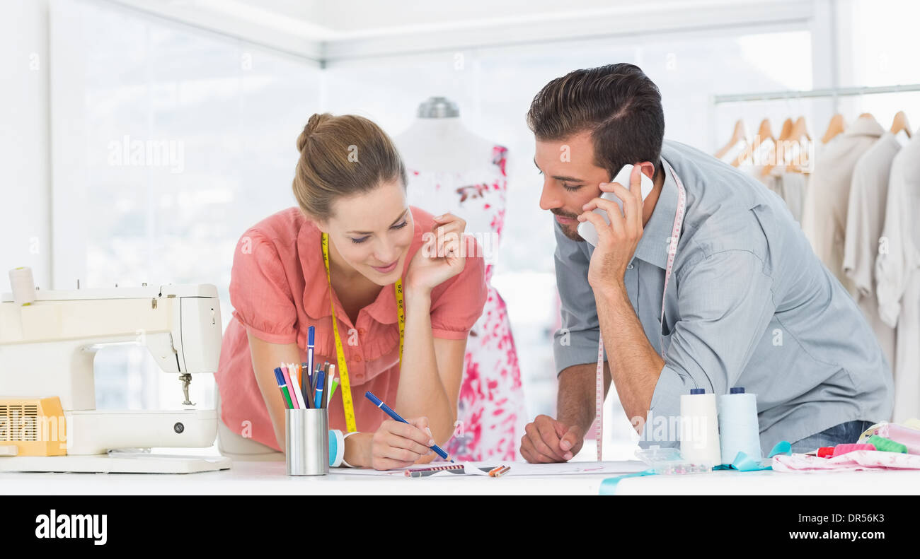 Fashion designers at work in bright studio Stock Photo - Alamy
