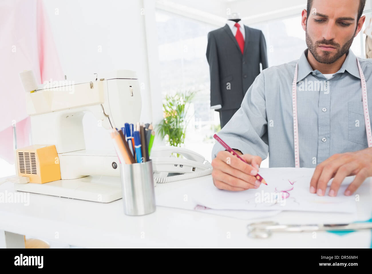 Fashion designer working on his designs in studio Stock Photo - Alamy