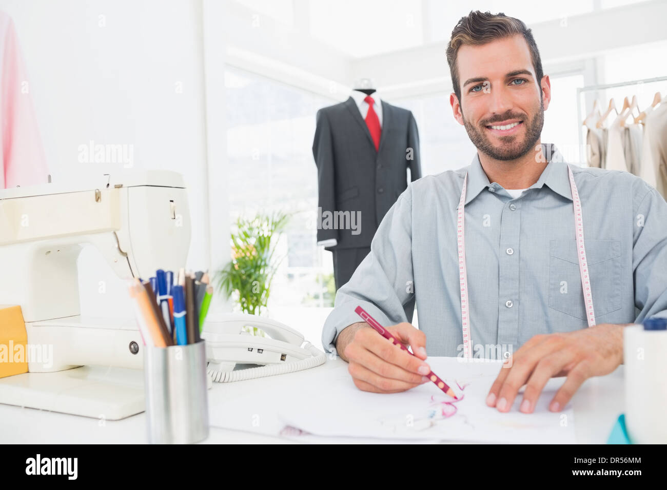 Fashion designer working on his designs in studio Stock Photo - Alamy