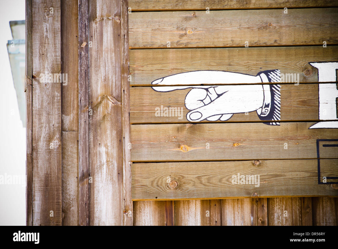 far west wall sign figer pointing direction Stock Photo - Alamy