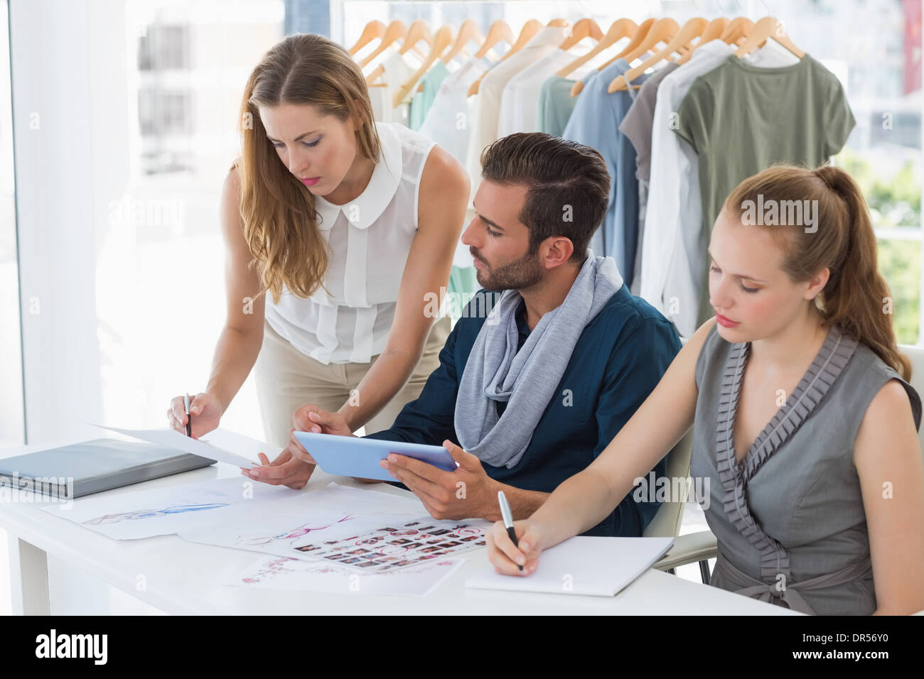 Three young designers sitting hi-res stock photography and images - Alamy