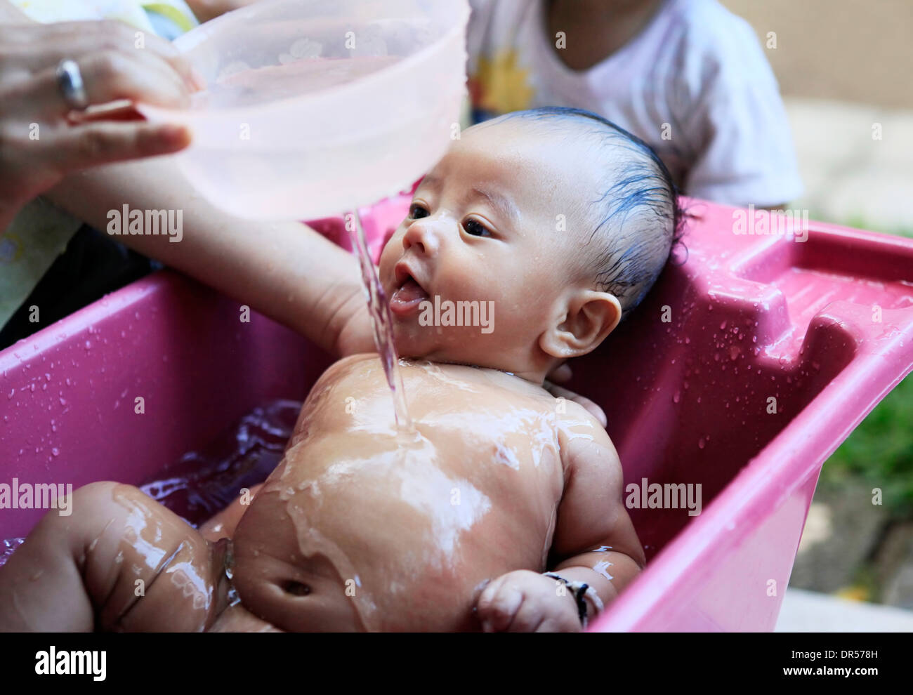 Mom washes young son. Indonesia, Bali Stock Photo - Alamy