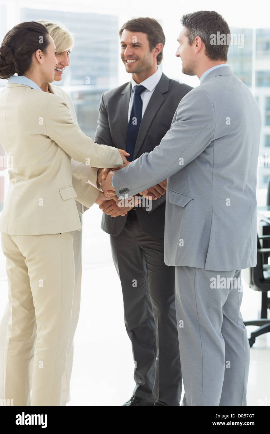 Business team joining hands together Stock Photo - Alamy