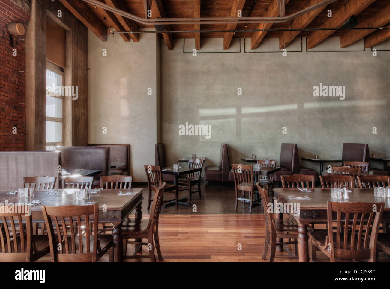 Tables and chairs in empty restaurant Stock Photo - Alamy