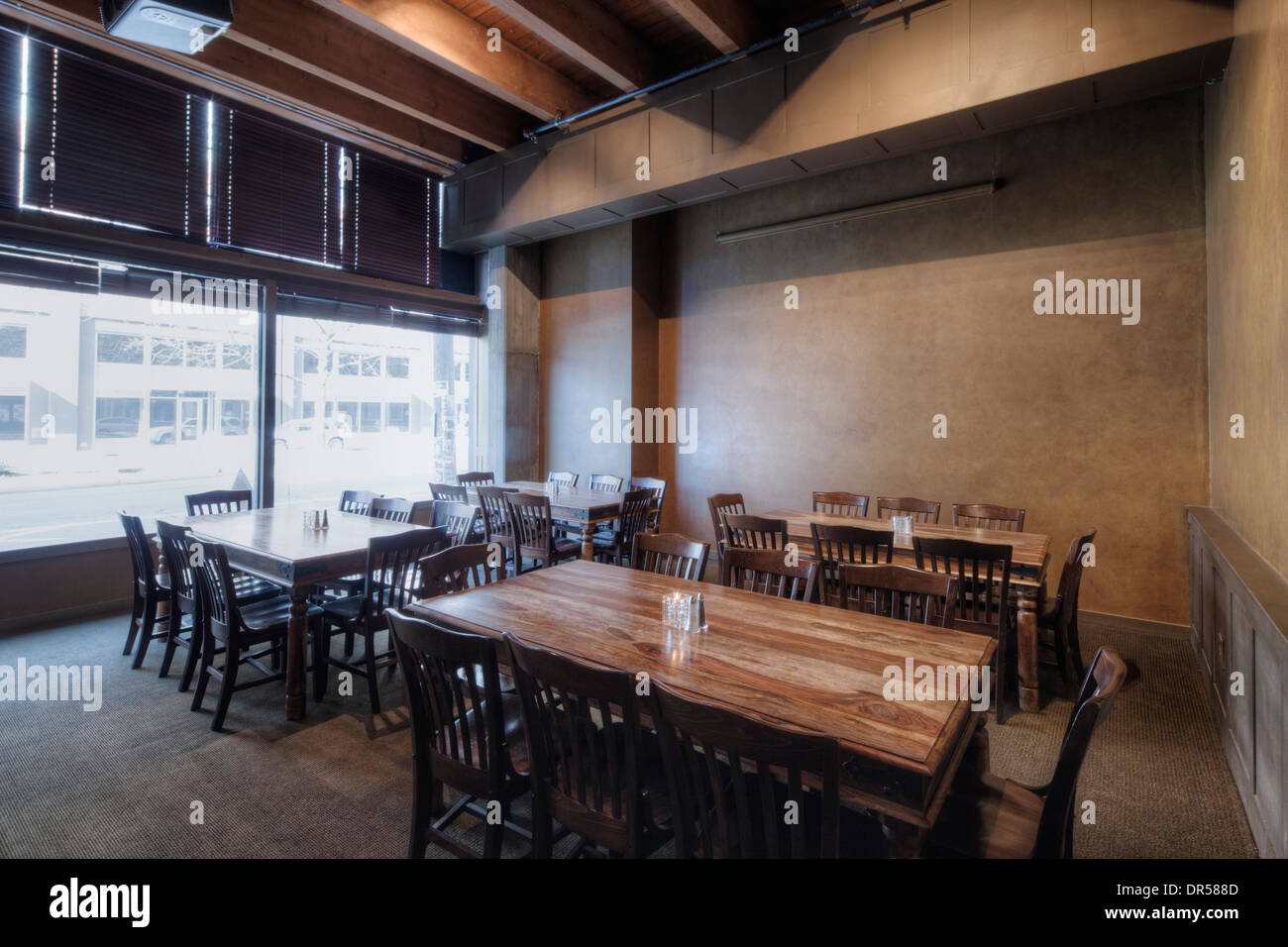 Tables and chairs in empty restaurant Stock Photo - Alamy