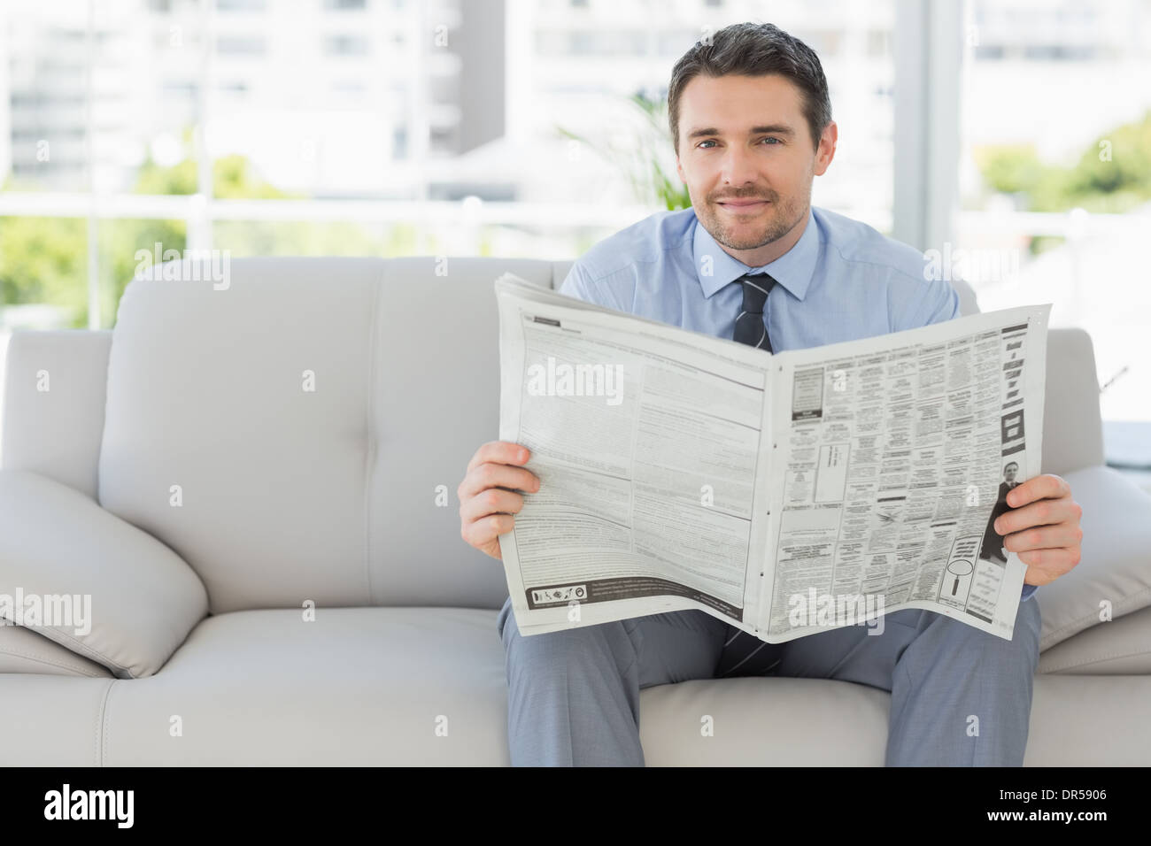 Portrait of a well dressed man reading newspaper Stock Photo - Alamy