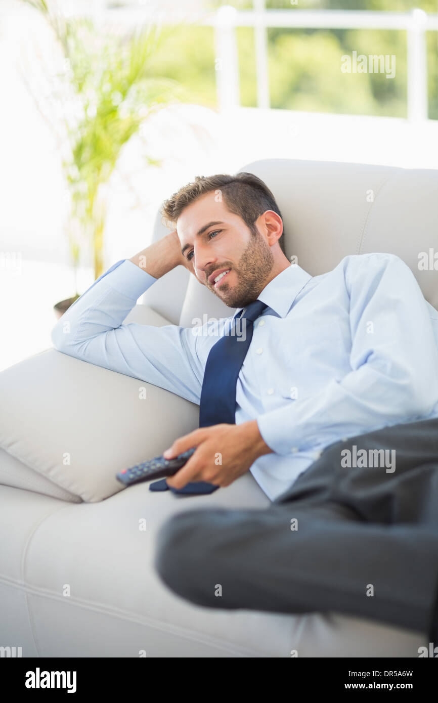 Well dressed man watching tv in living room Stock Photo - Alamy