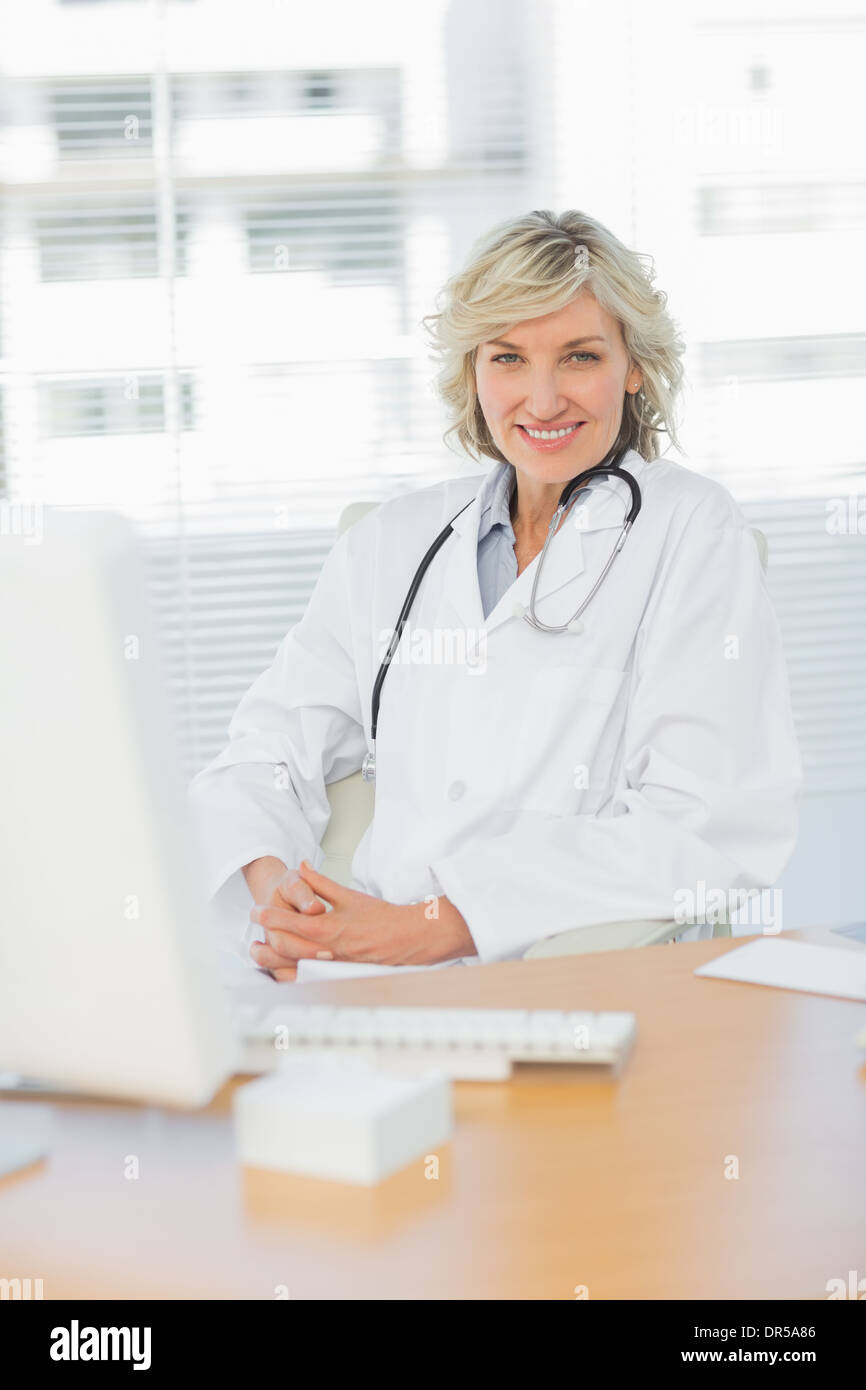 Female doctor sitting with computer at medical office Stock Photo - Alamy