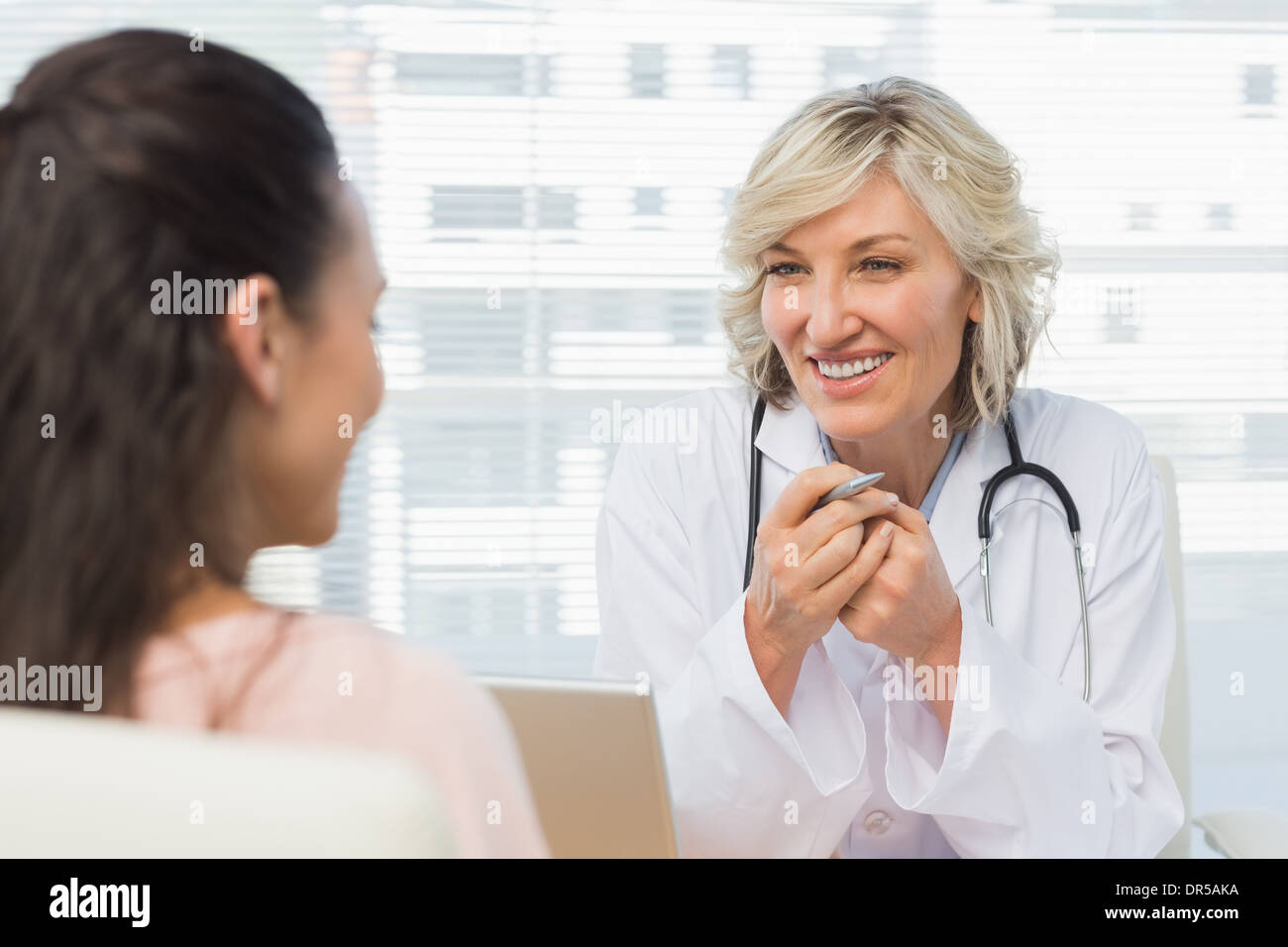 Friendly female doctor in conversation with patient Stock Photo - Alamy