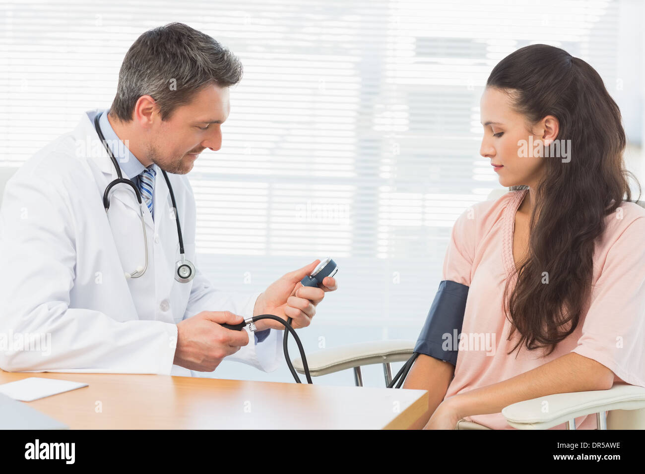 Checking blood pressure hi-res stock photography and images - Alamy