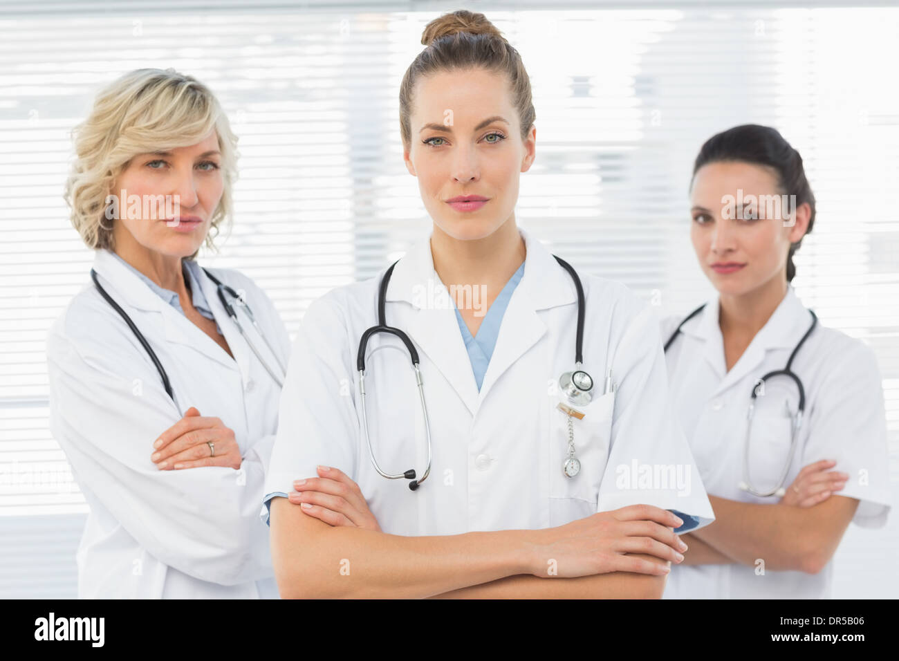 Three confident female doctors with arms crossed Stock Photo - Alamy