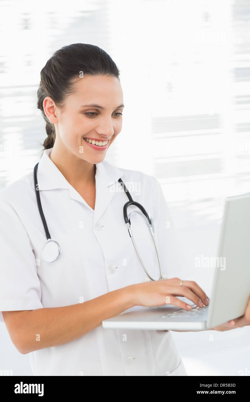 Female doctor using computer smiling hi-res stock photography and ...